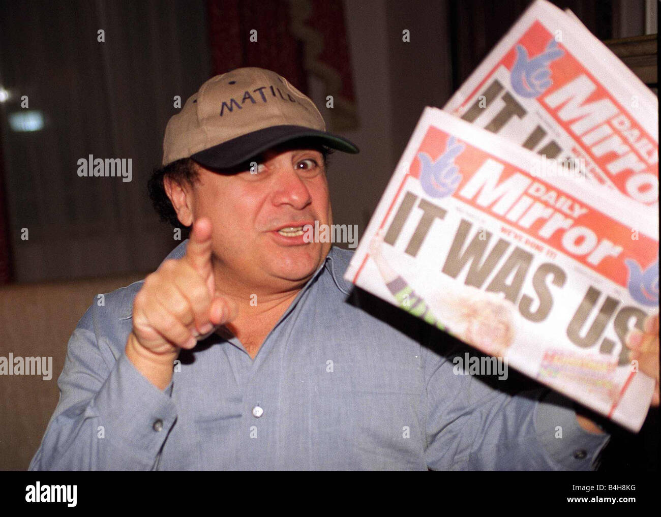 Danny DeVito Actor holding the Daily Mirror Newspaper Stock Photo - Alamy