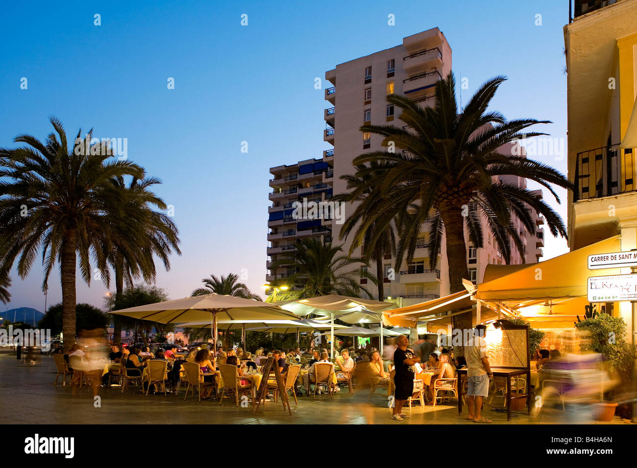 Tourists at sidewalk cafe during dusk Ibiza Balearic Islands Spain ...