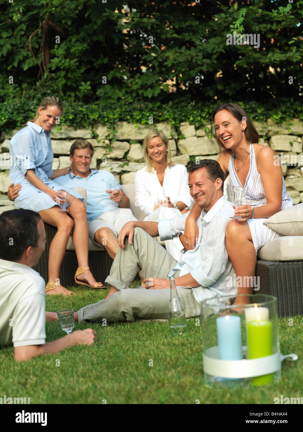 Three couples celebrating garden party Stock Photo - Alamy