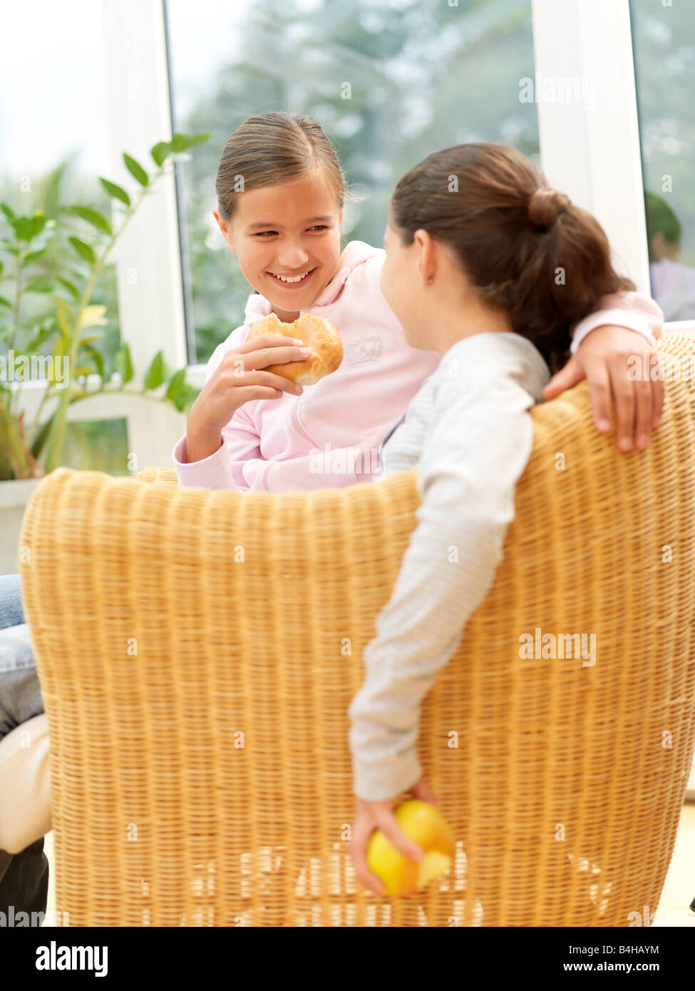 Two girls sitting on chairs hi-res stock photography and images - Alamy