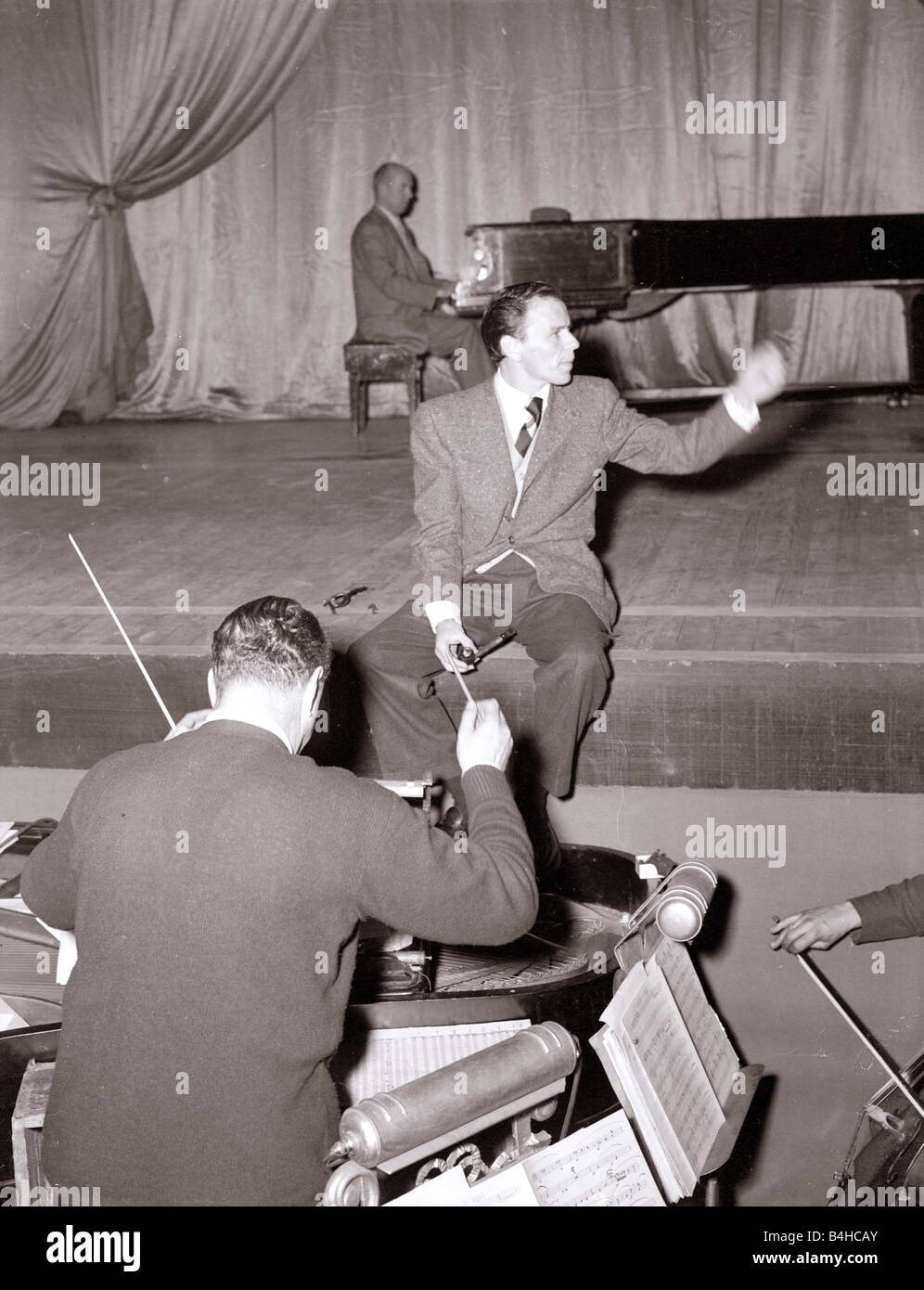 American singer and film star Frank Sinatra sitting on stage during ...