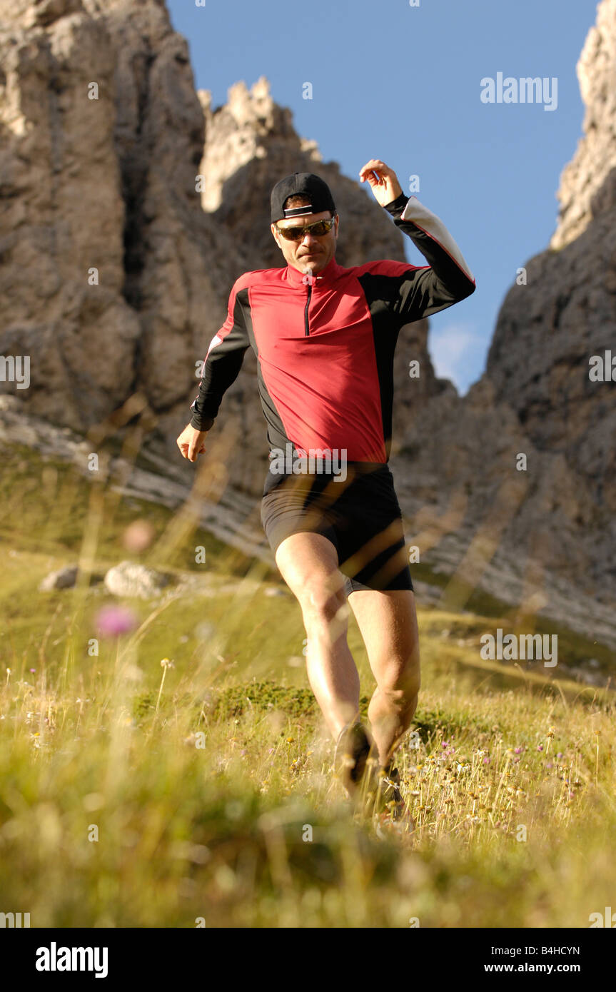 Mid adult man running on landscape Trentino-Alto Adige Italy Stock ...
