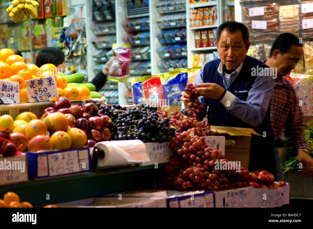 Old man working at Chinese grocer Stock Photo - Alamy