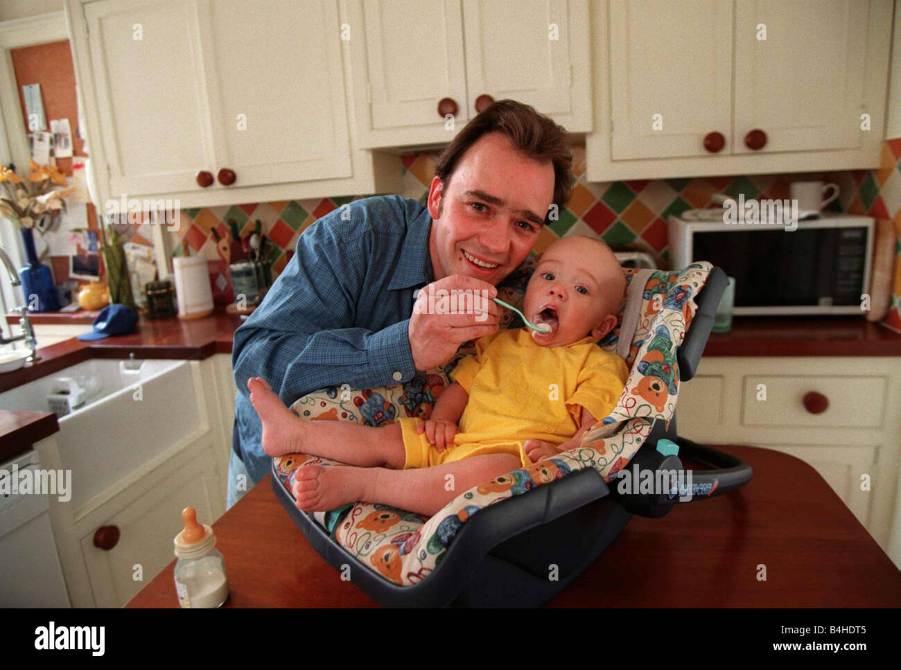 Actor Todd Carty at home with baby son James 1997 Stock Photo - Alamy