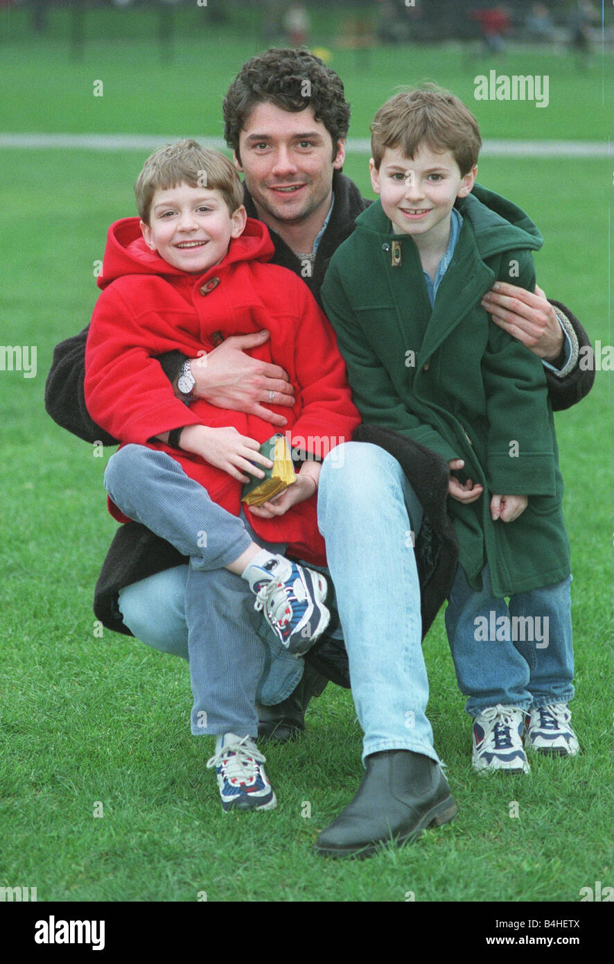 Dominic Taylor actor with his sons Arthur 6 in red coat and Jack 7 in ...