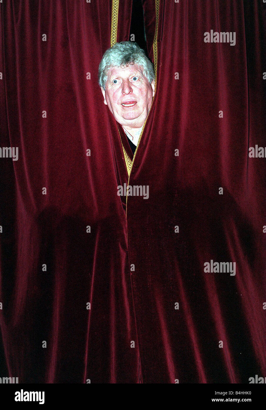 Tom Baker British actor Dec 1998 Peering out from behind stage curtains ...