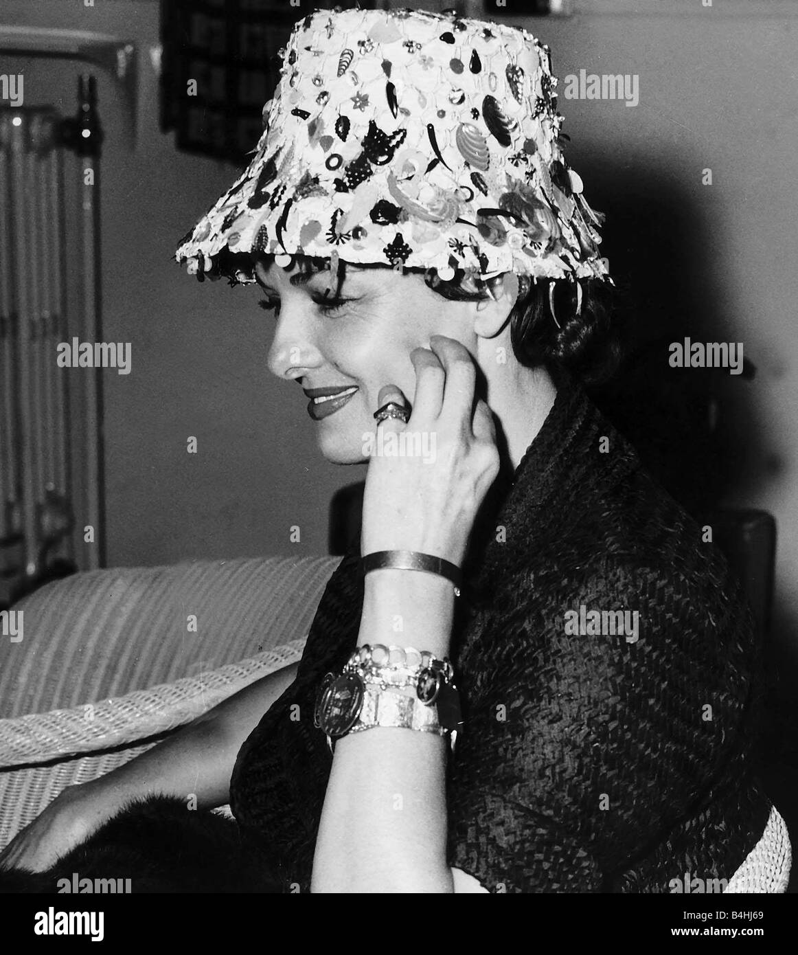 American actress Jane Russell wearing flowerpot hat holding her hand to ...