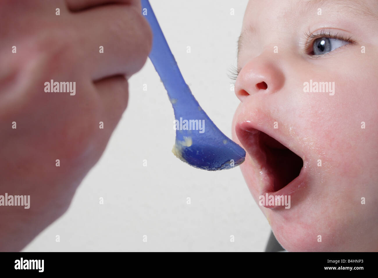 little baby being spoonfed Stock Photo - Alamy