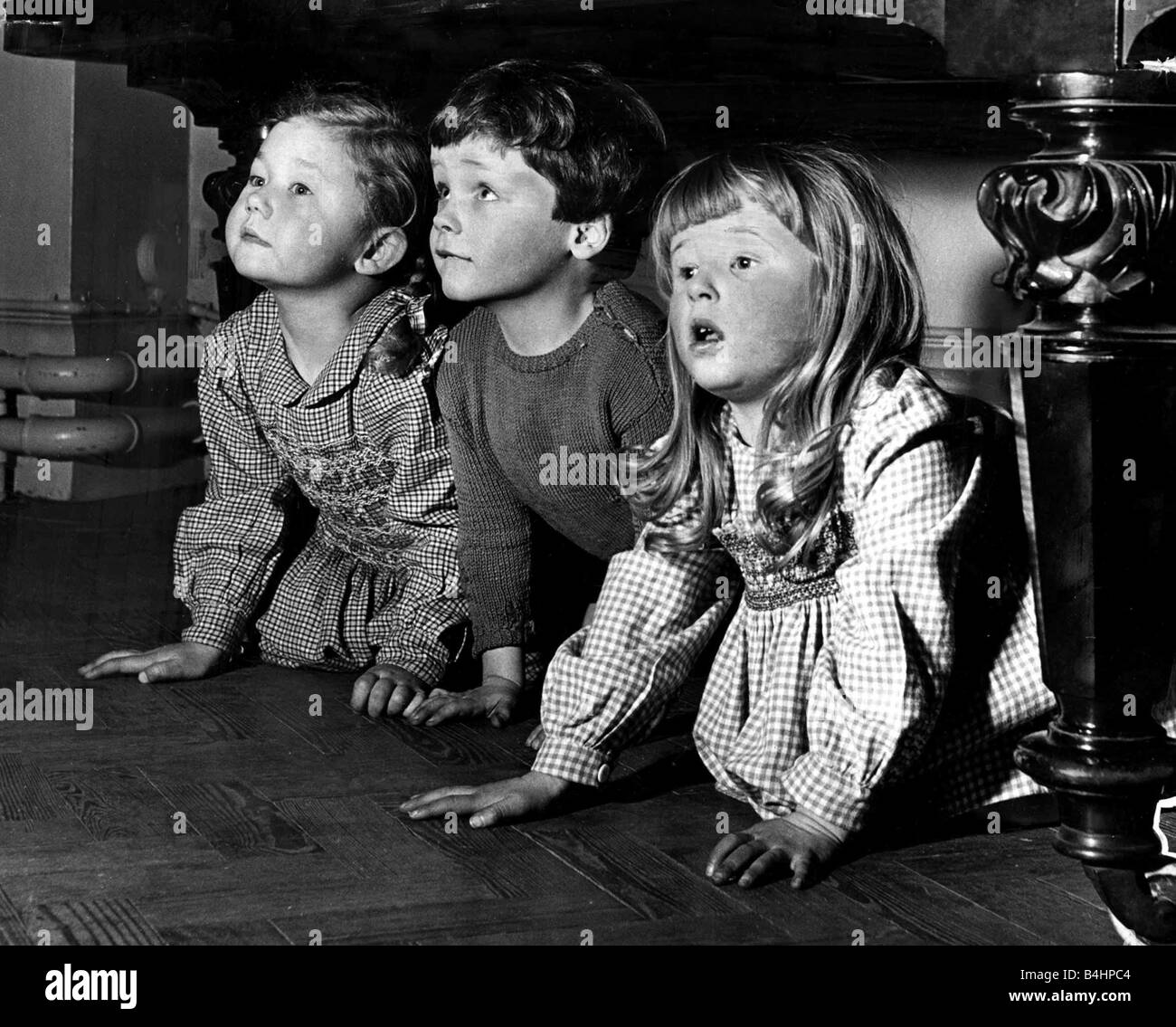 Three children hide underneath a piano Stock Photo - Alamy