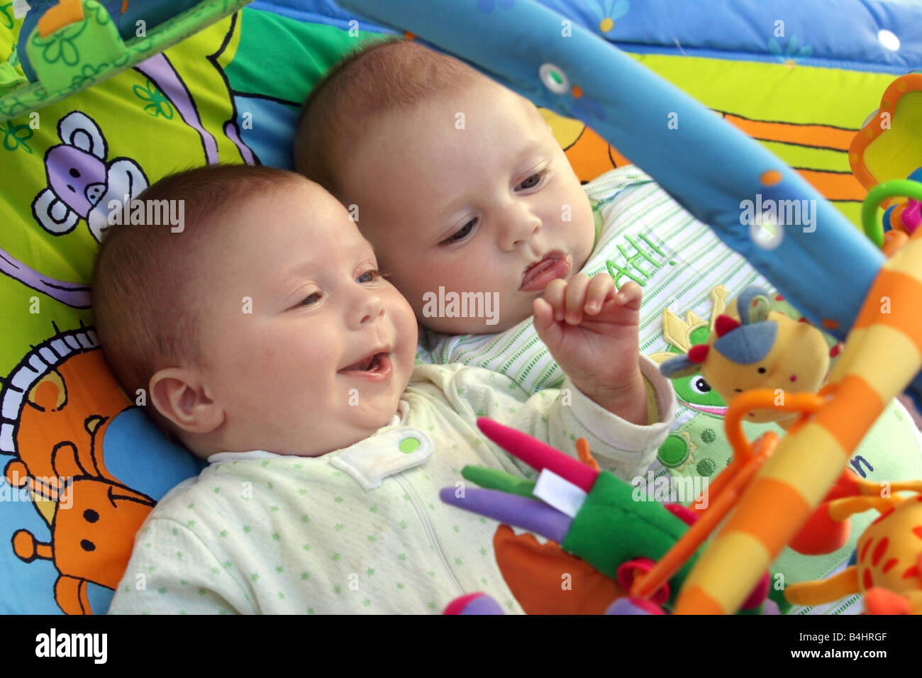 Two baby boys twin brothers playing together Stock Photo - Alamy