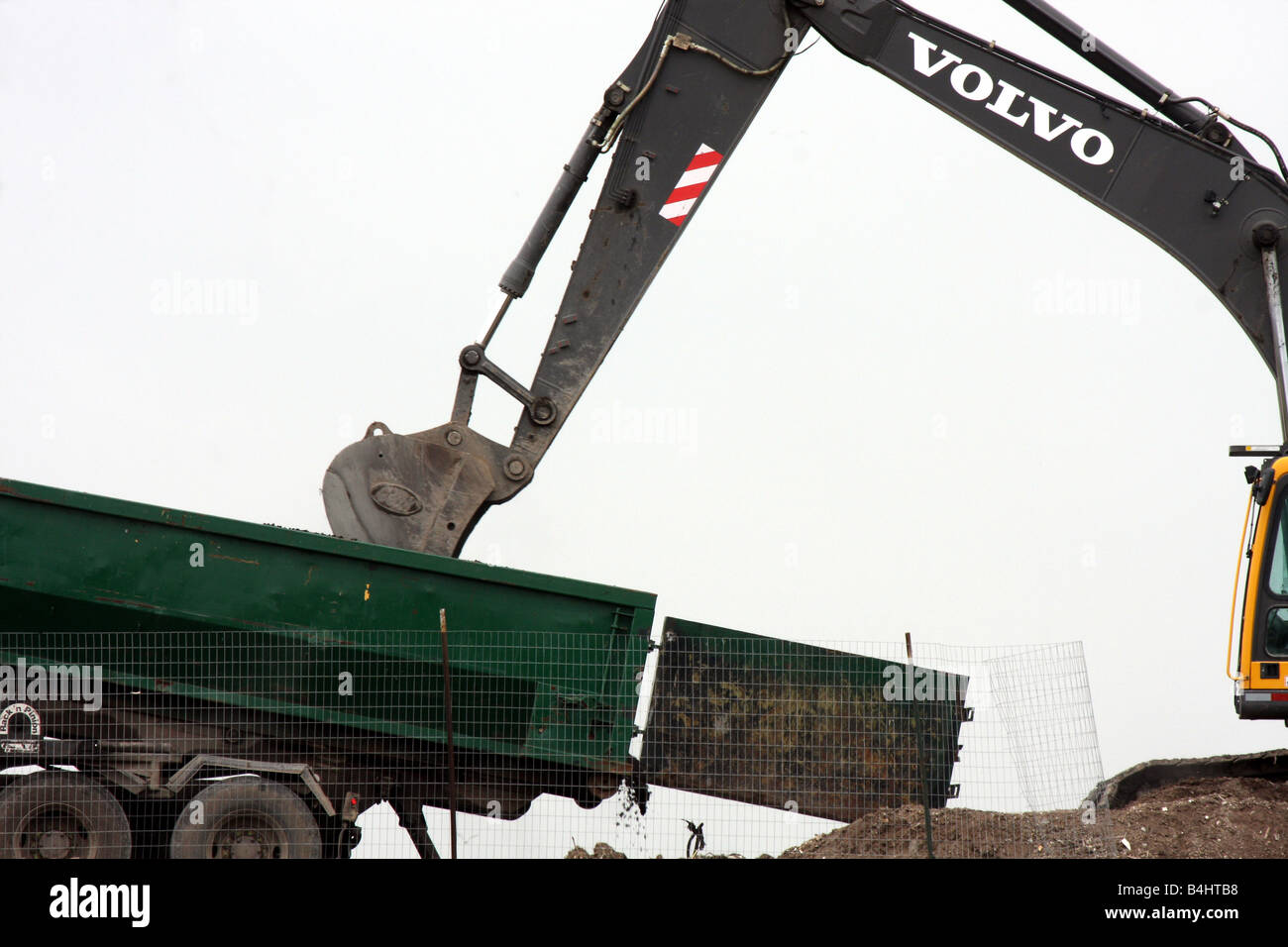Landfill backhoe removing trash from a garbage truck in Menomonee Falls ...