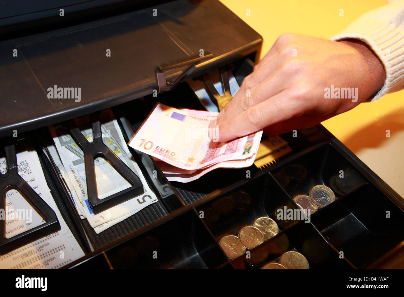 putting money Euros in till Stock Photo - Alamy