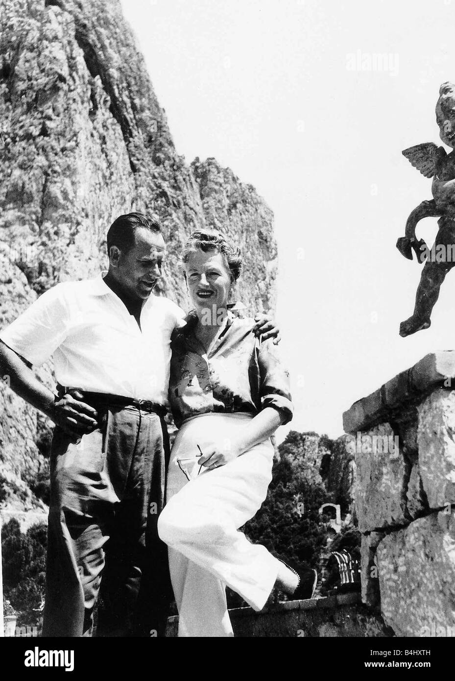 Actress and singer Gracie Fields standing on a rock with her husband ...