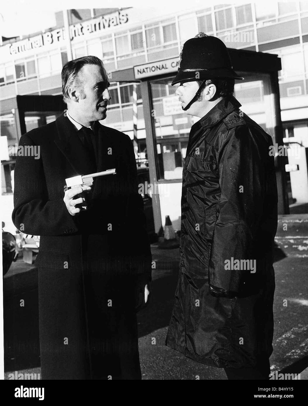 Christopher Lee pointing his Golden Gun at a policeman after his ...