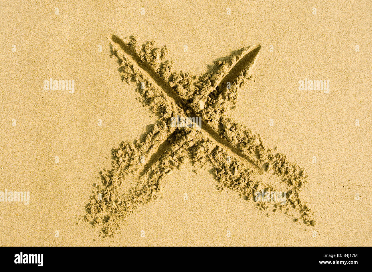 Cross drawn in the sand Stock Photo - Alamy