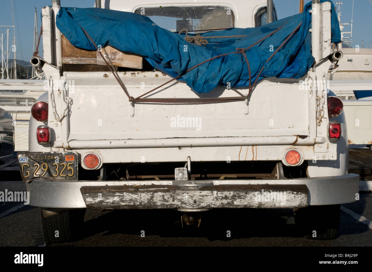 The back of a fully loaded classic old chevrolet truck in a car park ...