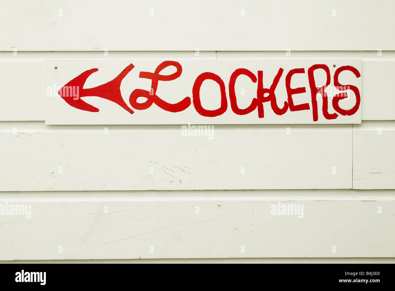 Red hand painted lockers sign with arrow Stock Photo - Alamy