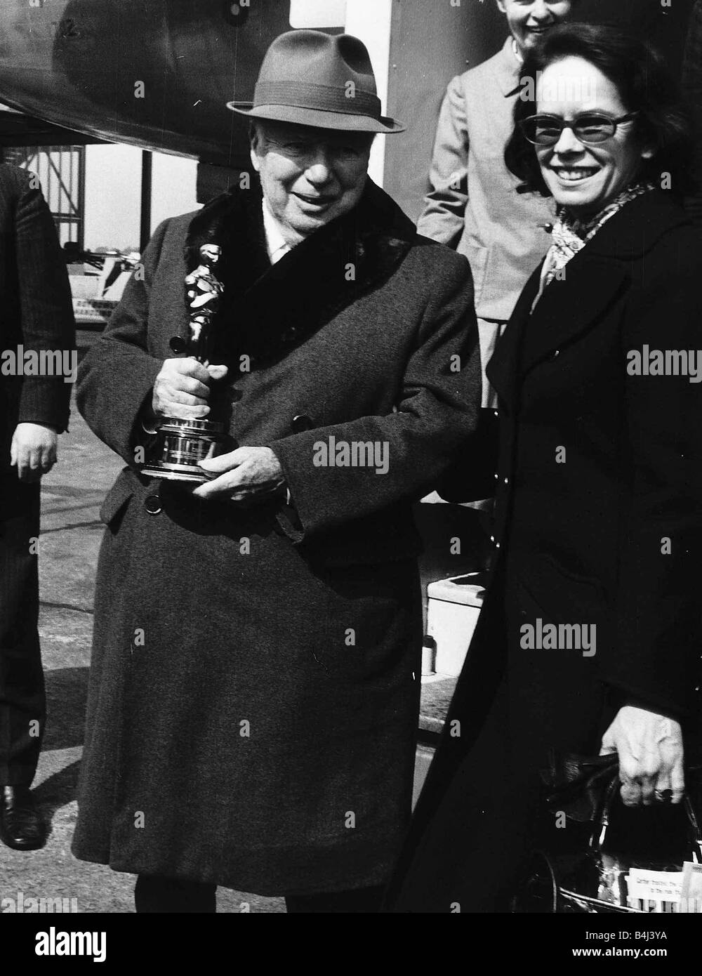 Charlie Chaplin Actor At heathrow airport with his wife Dona holding ...