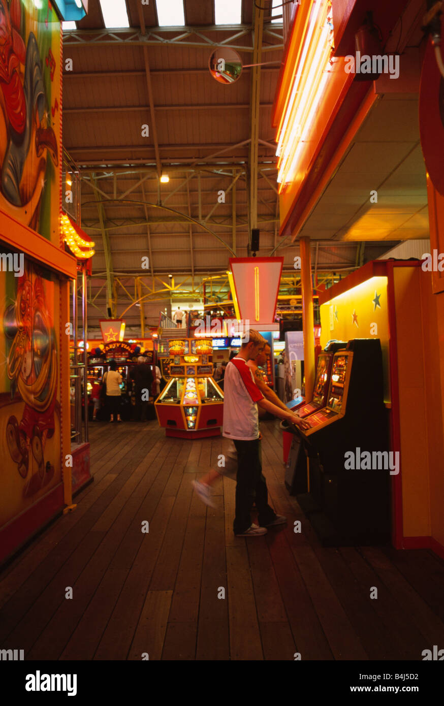 Men playing the slot machines at Amusement Arcade at Weston Super Mare ...