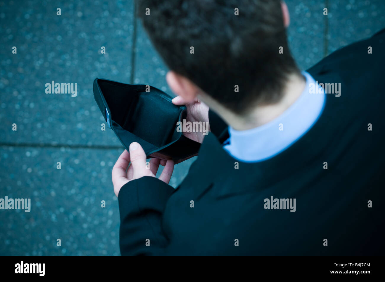 Young businessman checking his wallet Stock Photo - Alamy