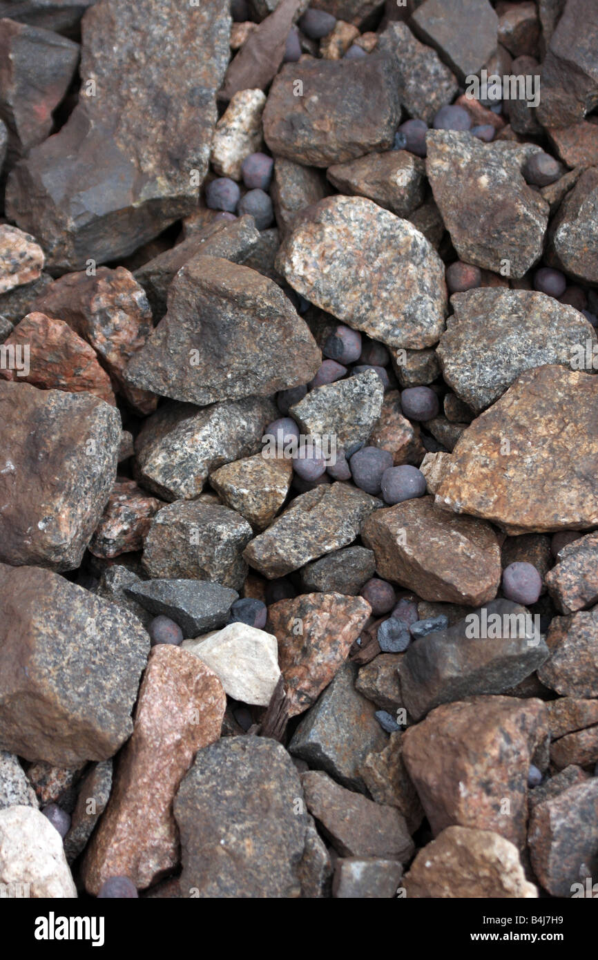 Stones and rocks in the railroad bed between the rails with iron ore ...