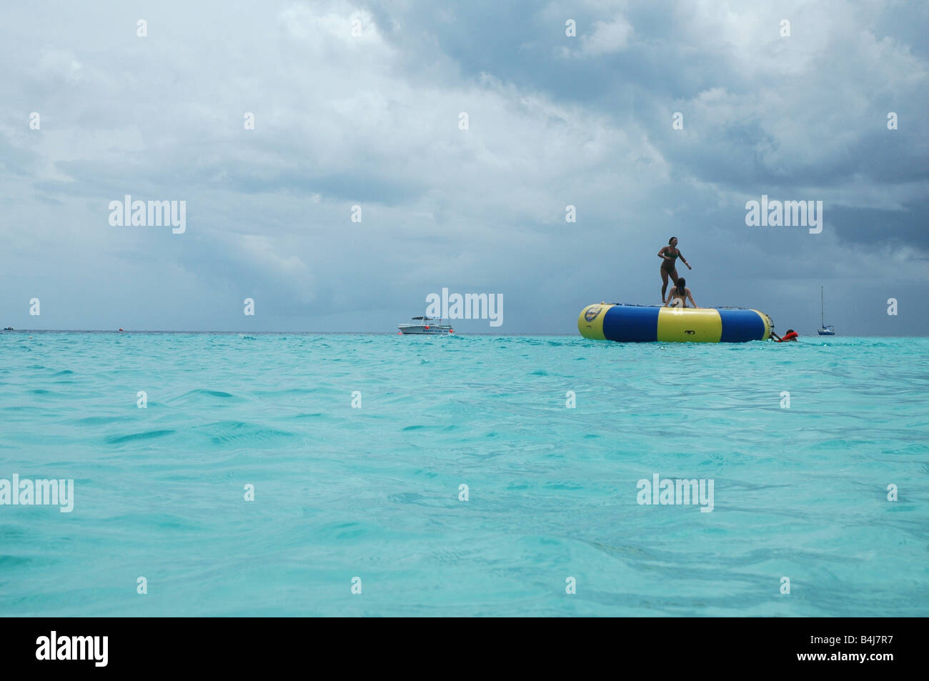 people bouncing and playing on inflatable innertube raft in the ...