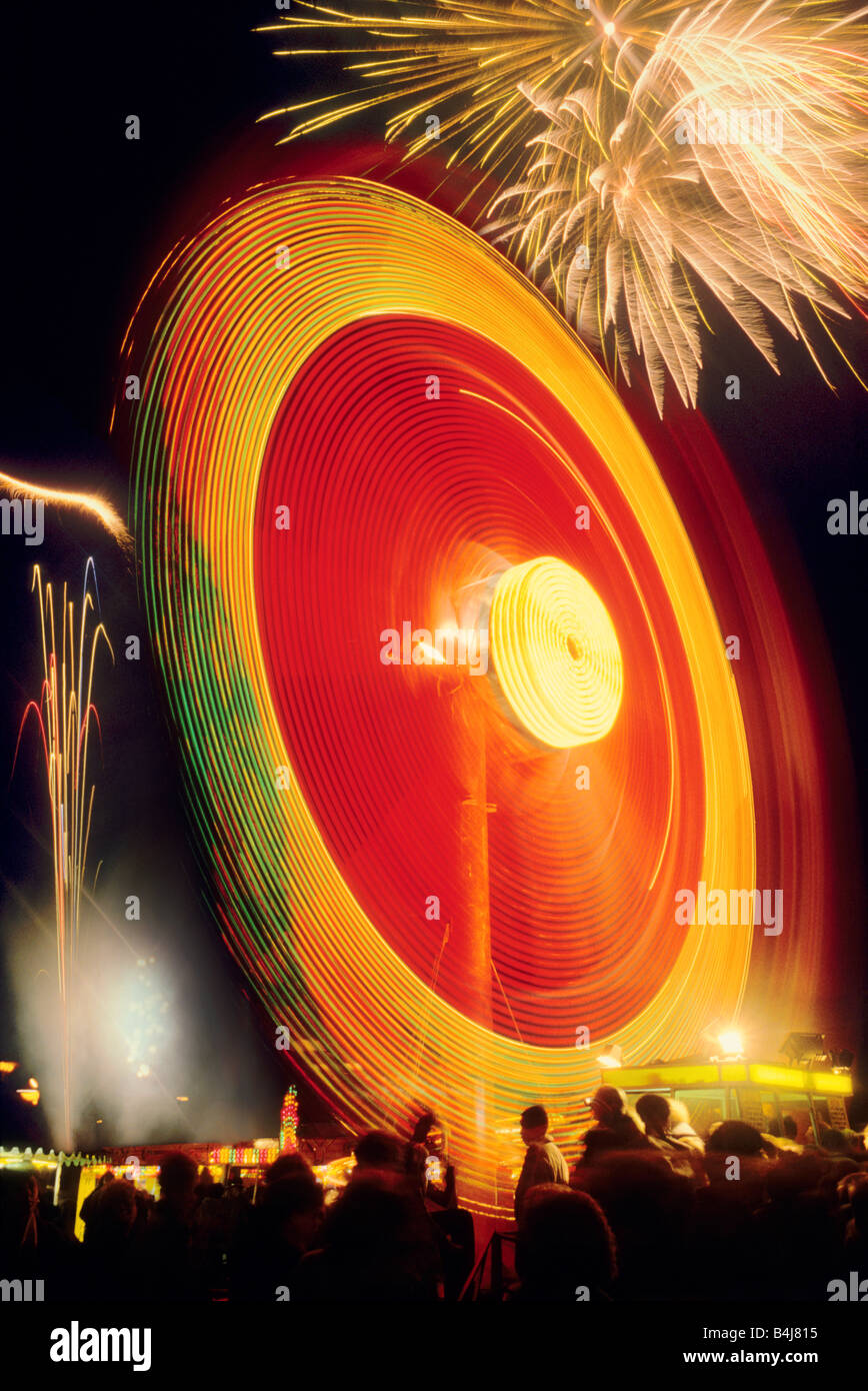 Spinning fairground ride and fireworks display England UK Stock Photo ...