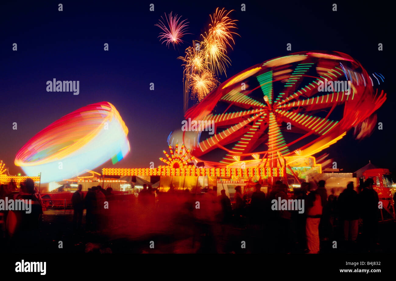 Spinning fairground ride at night England UK Stock Photo - Alamy