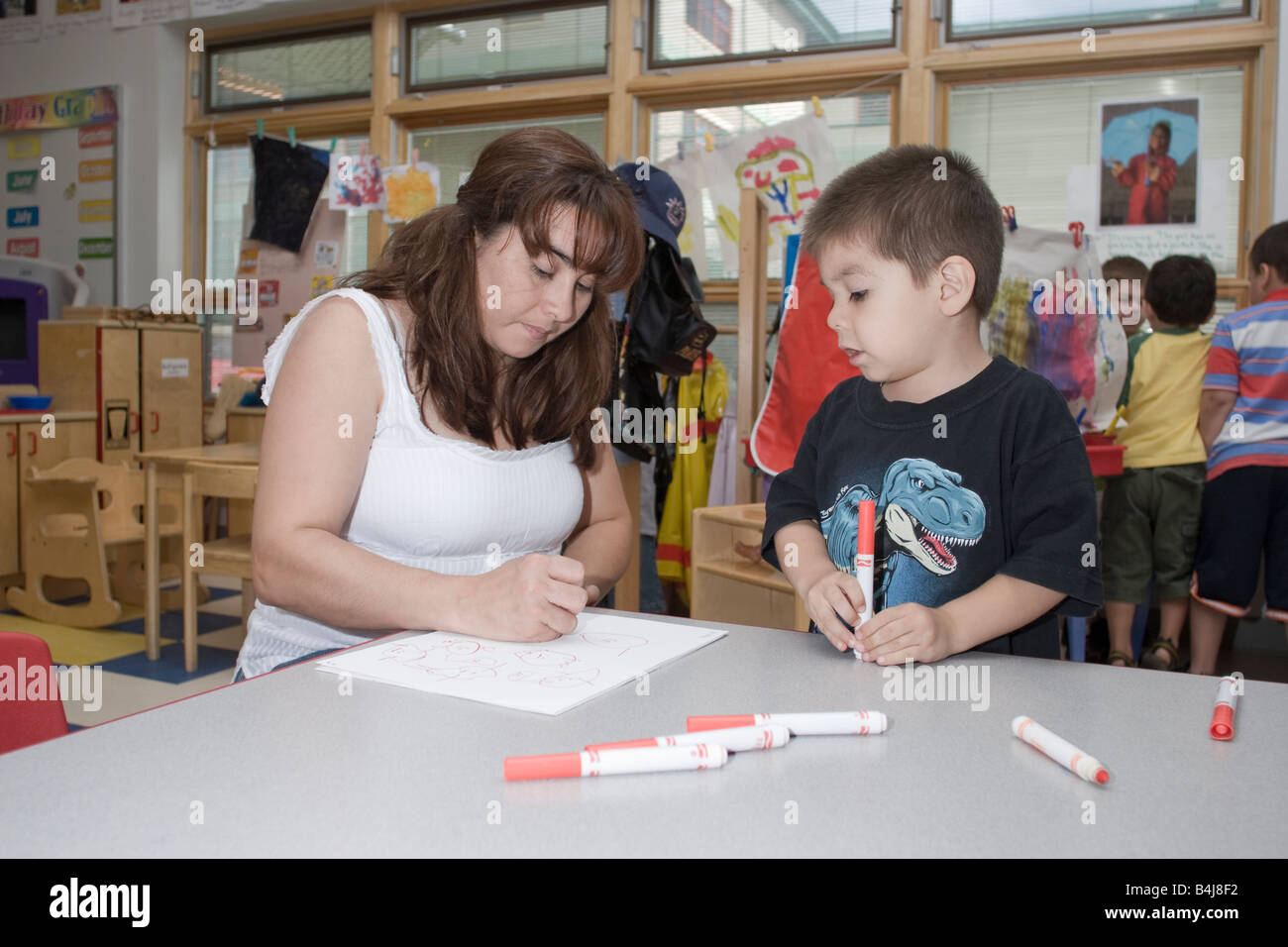 Preschool teacher helping year old hi-res stock photography and images ...