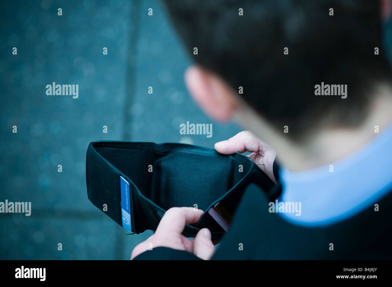 Young businessman checking his wallet Stock Photo - Alamy