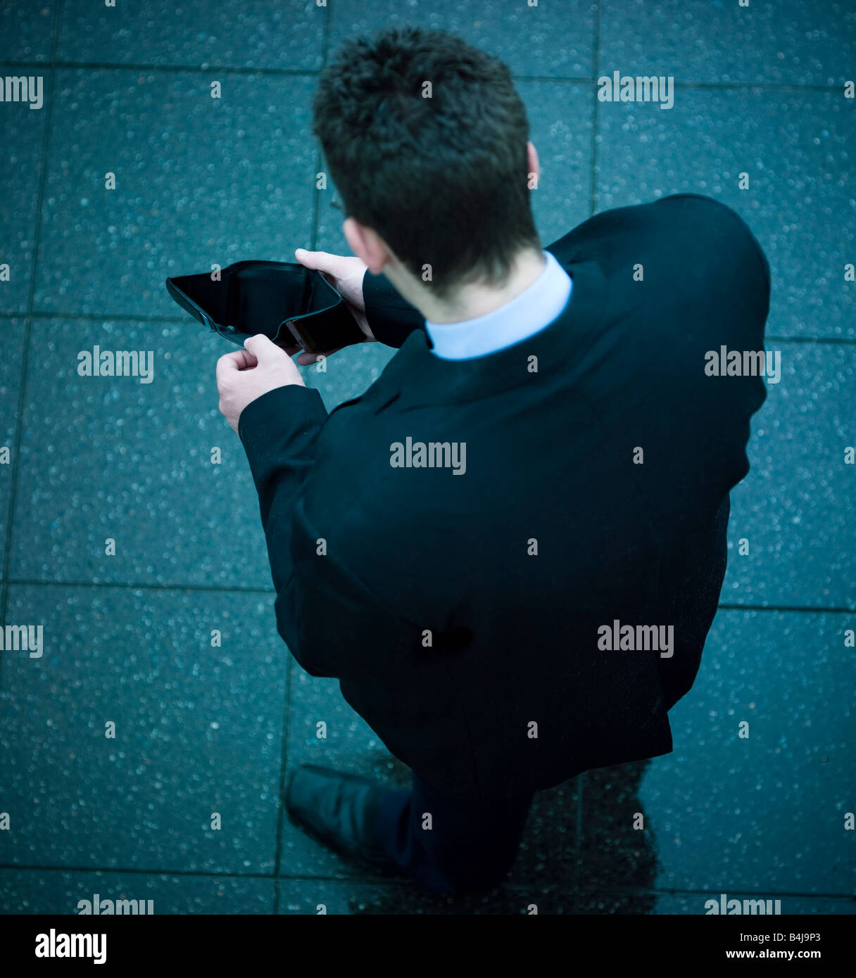 Young businessman checking his wallet Stock Photo - Alamy