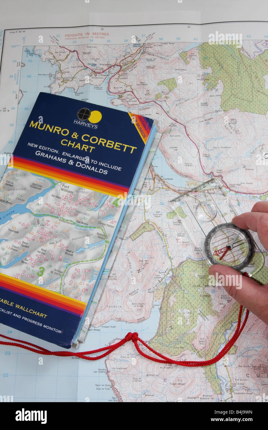 Walker Using a Map Chart and Compass to Plan a Trip Into the Mountains ...