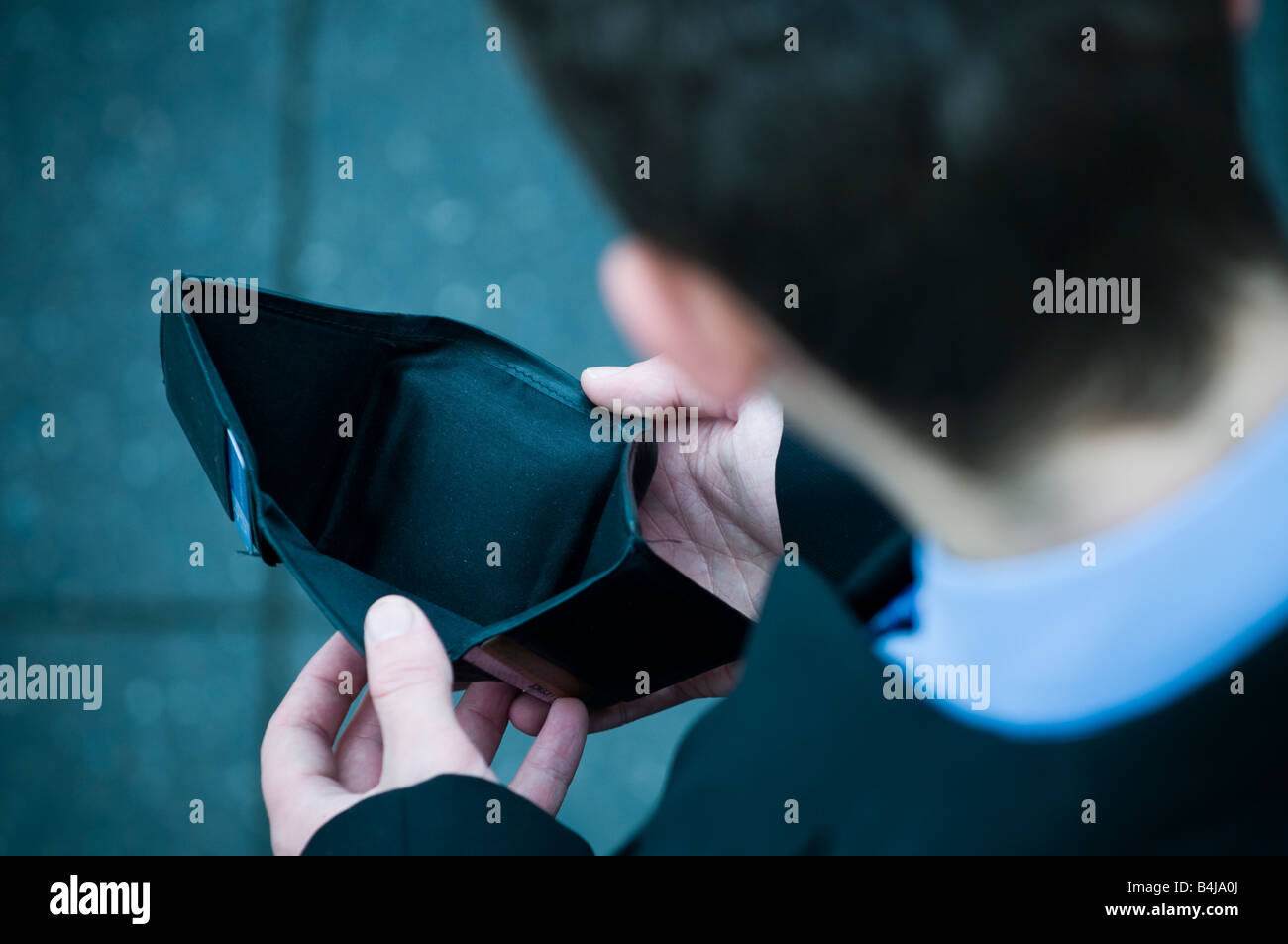 Young businessman checking his wallet Stock Photo - Alamy