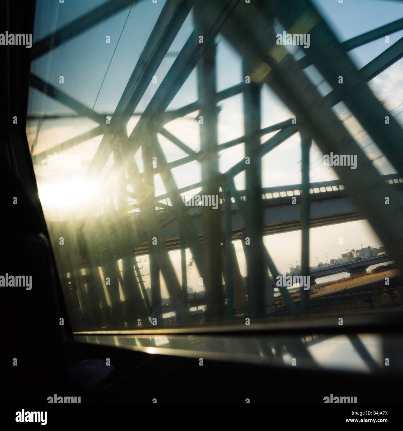 japan train window steel bridge sunburst blue sky speed over tokyo ...