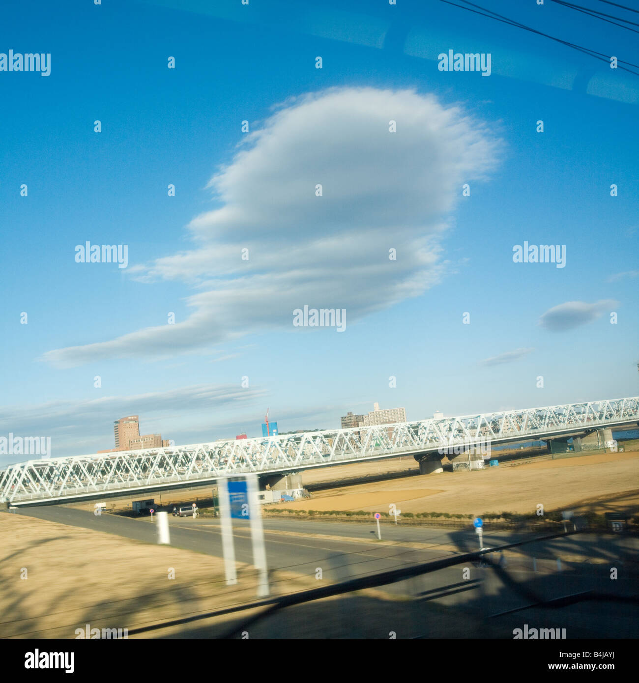 japan yokohama train window steel bridge solitary cloud blue sky speed ...