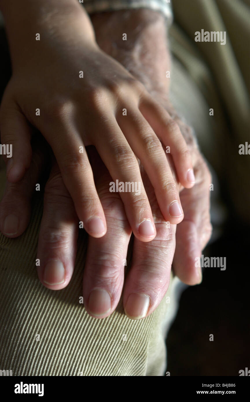 young person s hand resting on an elderly man s hand Stock Photo - Alamy