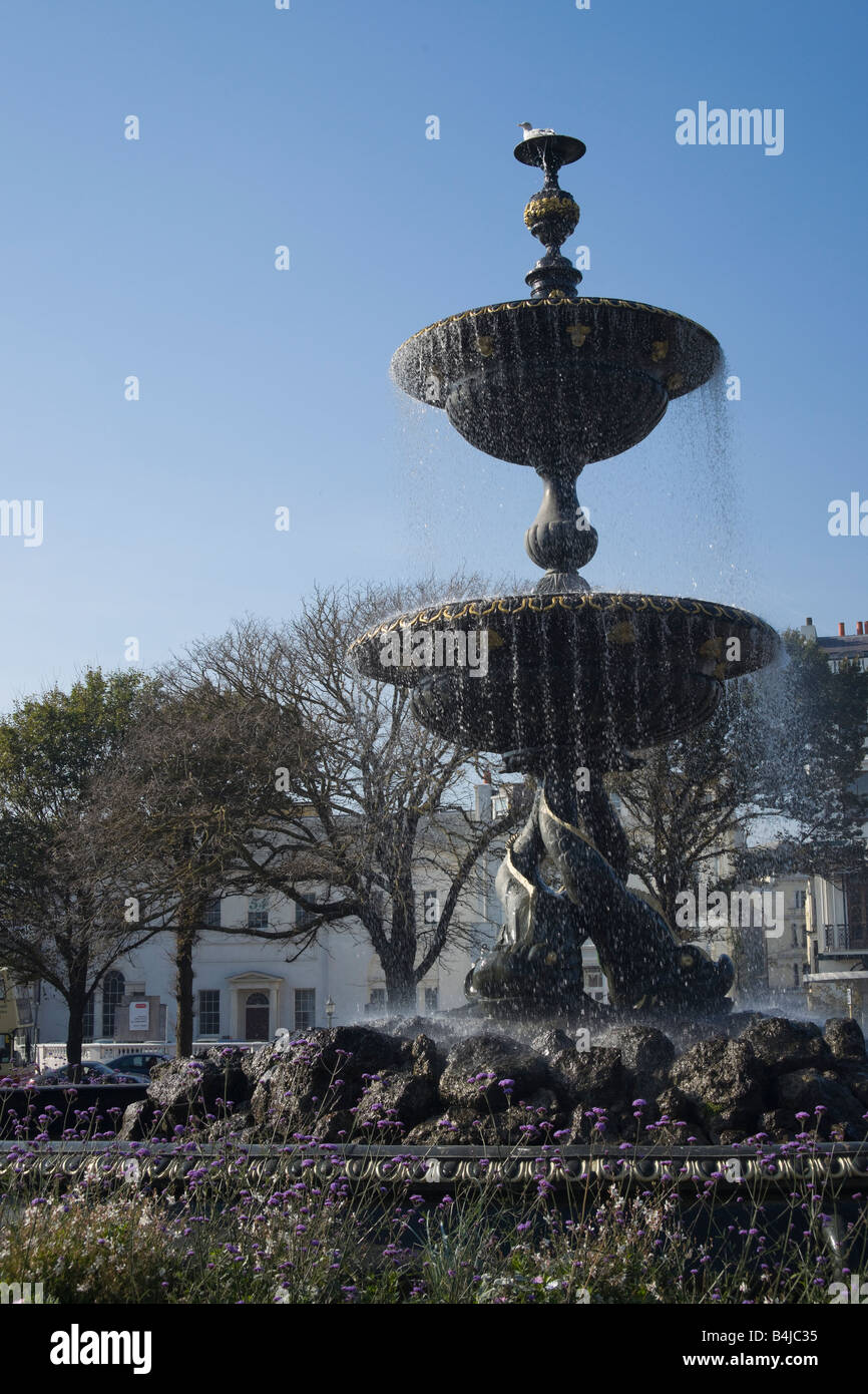 Detail of old metal traditional fountain with purple flowers in ...