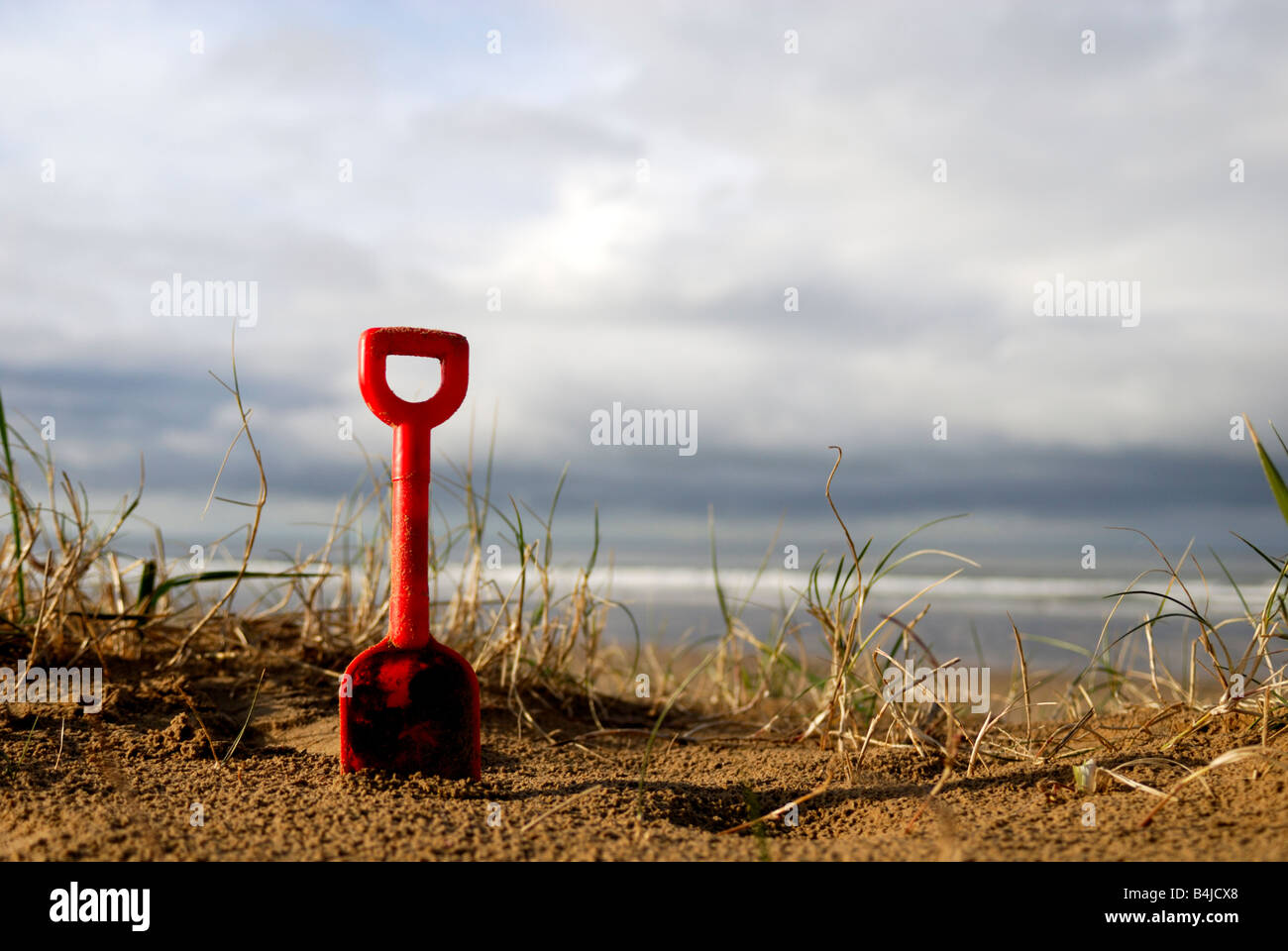 childs spade in sand dunes on beach Stock Photo - Alamy