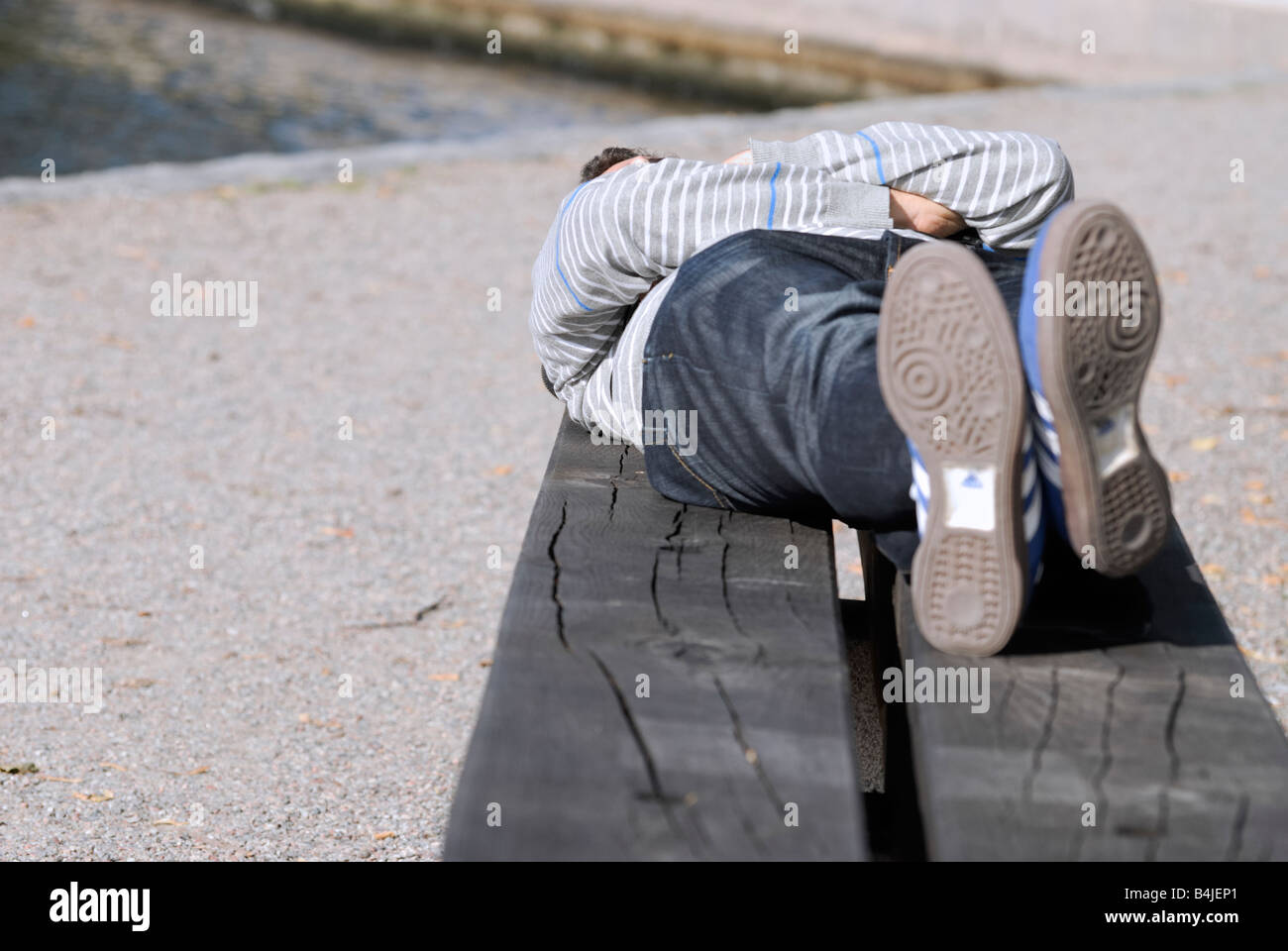 A young man overlays the bench Stock Photo - Alamy