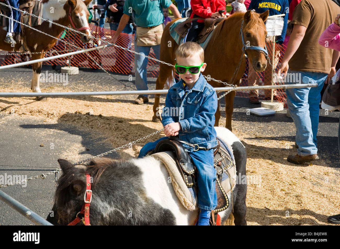 Kids Pony Ride at Festival Stock Photo - Alamy