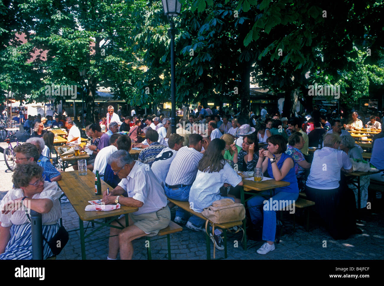 German people eating lunch at restaurant beer garden in Victuals Market ...