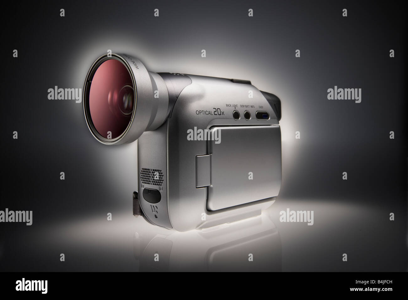 Consumer hand-held digital video camera on a translucent reflection ...