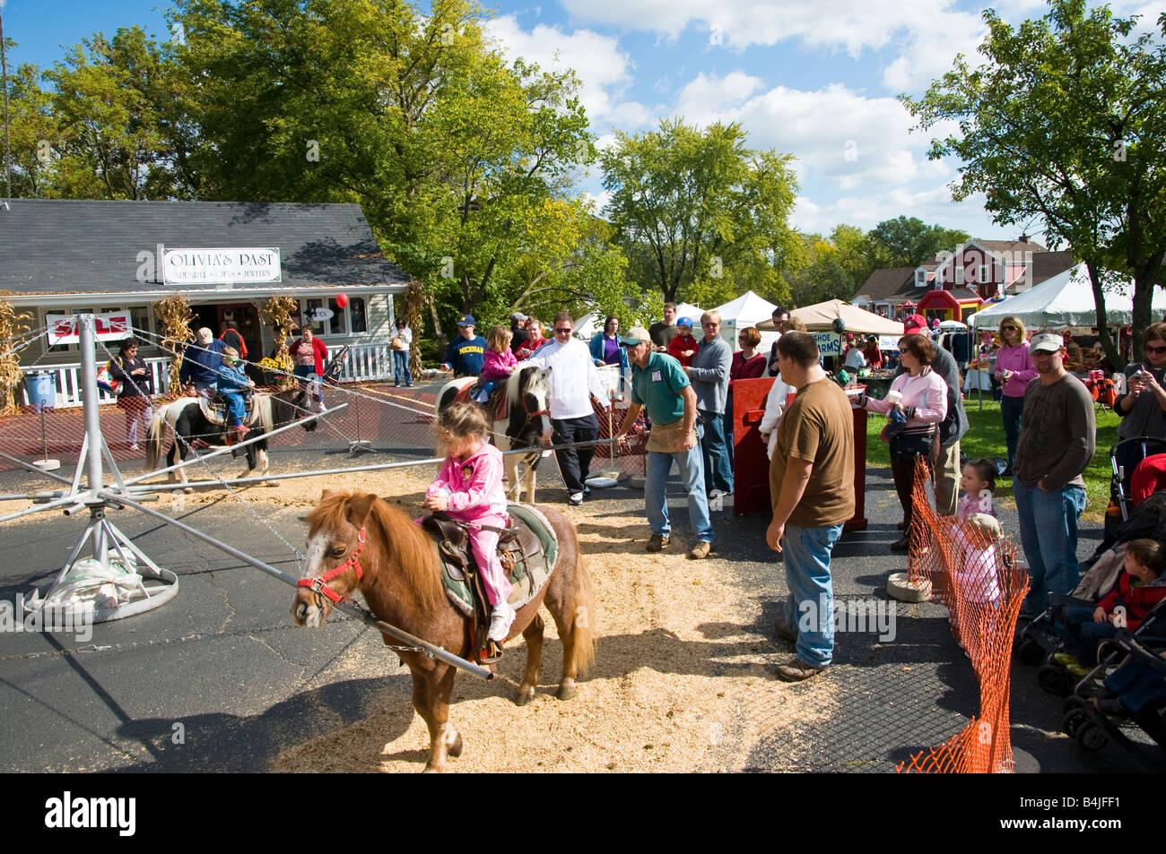 Kids Pony Ride at Festival Stock Photo - Alamy