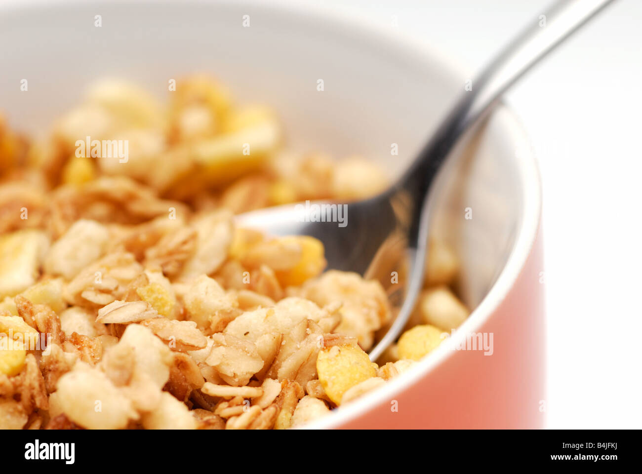 Healthy breakfast, spoon in a bowl of muesli. White background ...