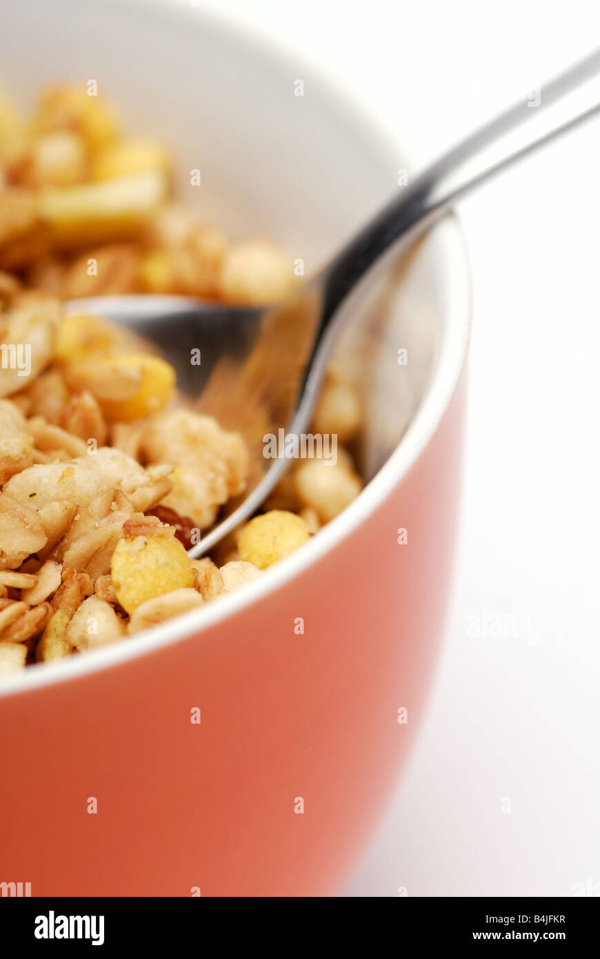 Healthy breakfast, spoon in a bowl of muesli. White background ...