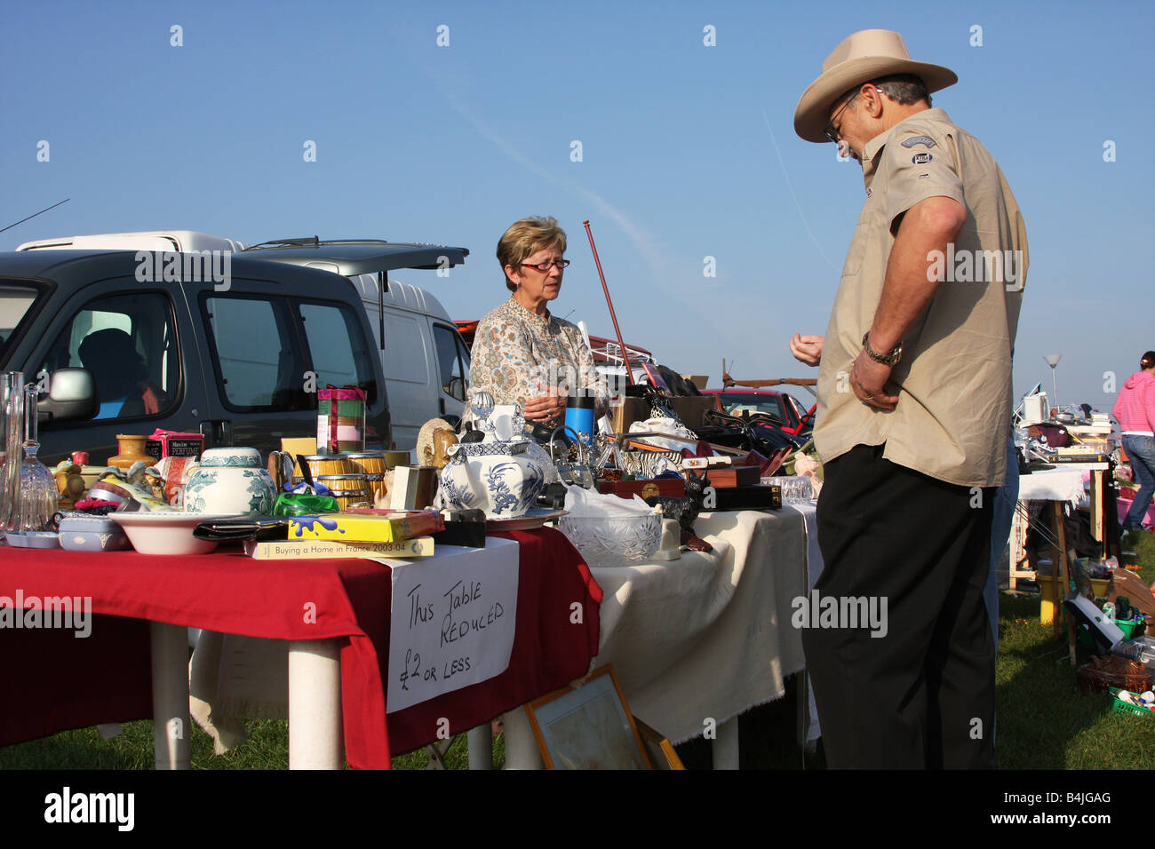 Stall holder and potential customer at a car boot sale Stock Photo - Alamy