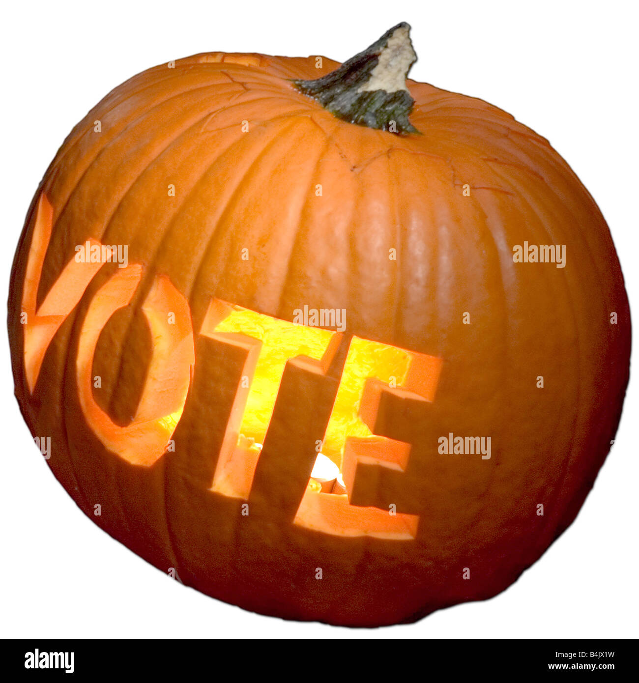 Glowing orange pumpkin carved with the word vote - encourages people to ...
