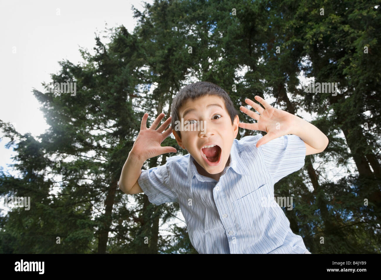 Asian boy yelling outdoors Stock Photo - Alamy