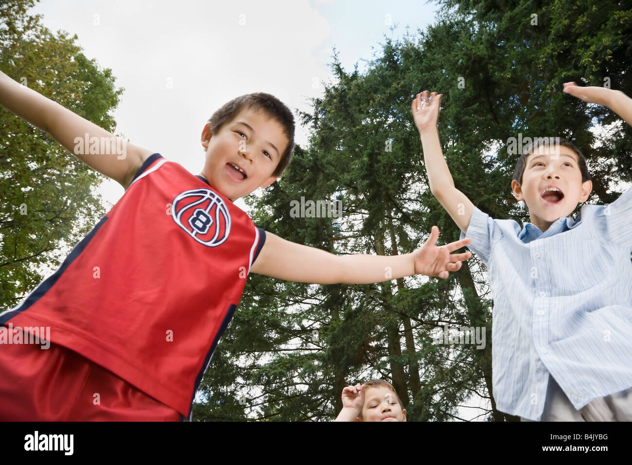 Asian brothers cheering outdoors Stock Photo - Alamy