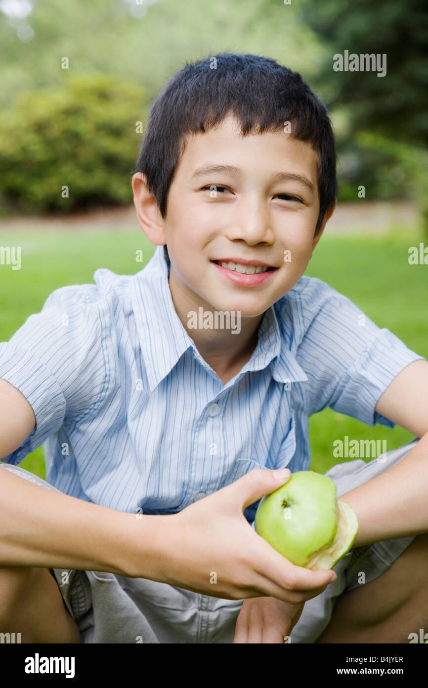Asian boy holding apple Stock Photo - Alamy